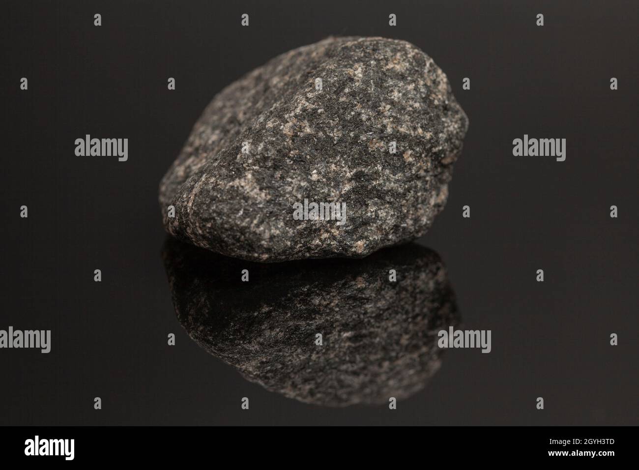 Granite stone on black background with reflection Stock Photo - Alamy