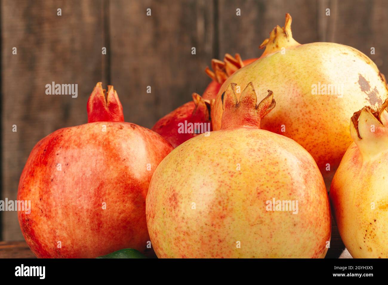 Group of pomegranate fruits close up background Stock Photo - Alamy