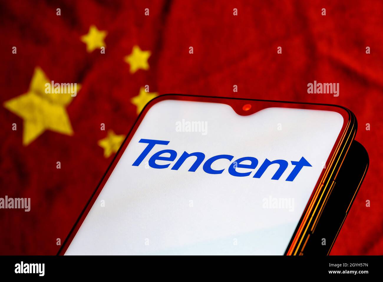 Smartphone with the Tencent logo on the background of the Chinese flag ...