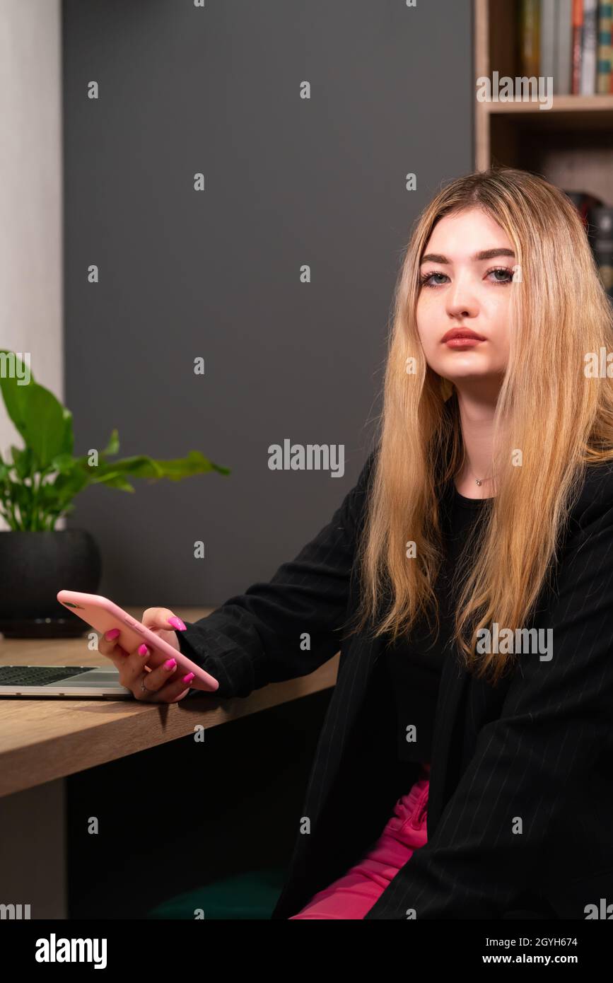 Serious businesswoman looking quietly at the camera with a deadpan ...
