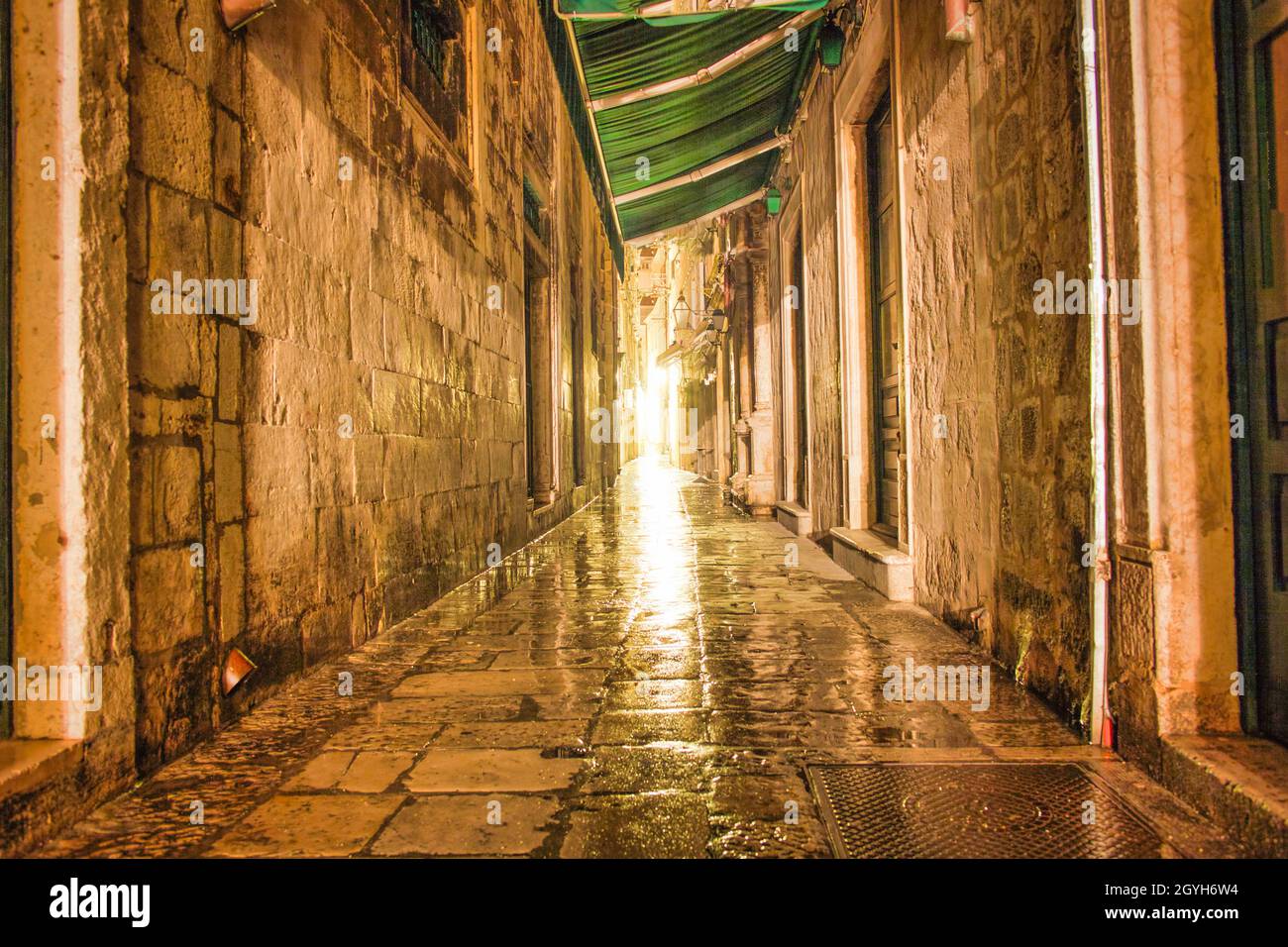 Old alleyway with lights through a building Stock Photo - Alamy