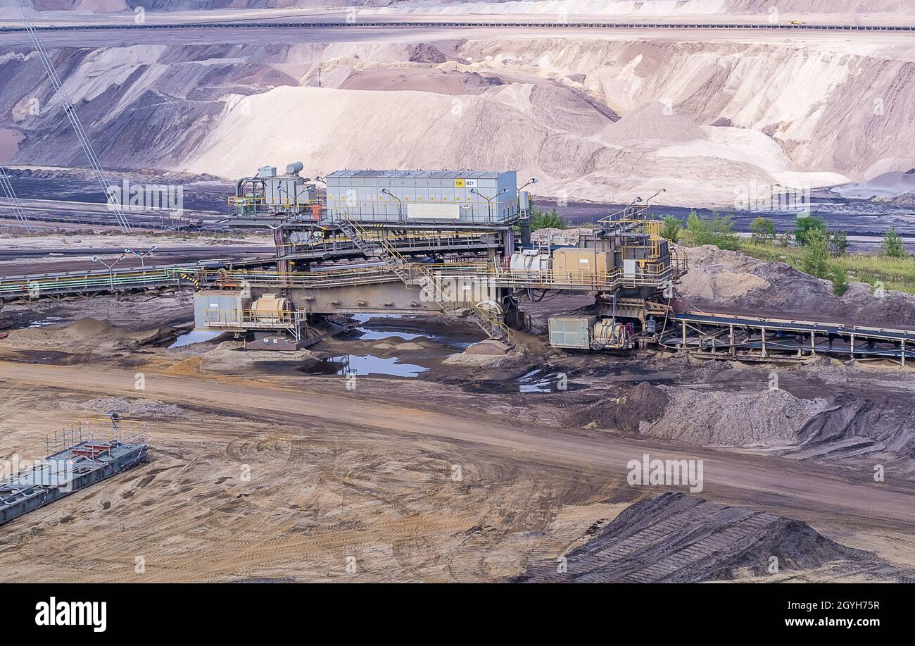 Brown coal open pit landscape with machinery conveyor belt in ...