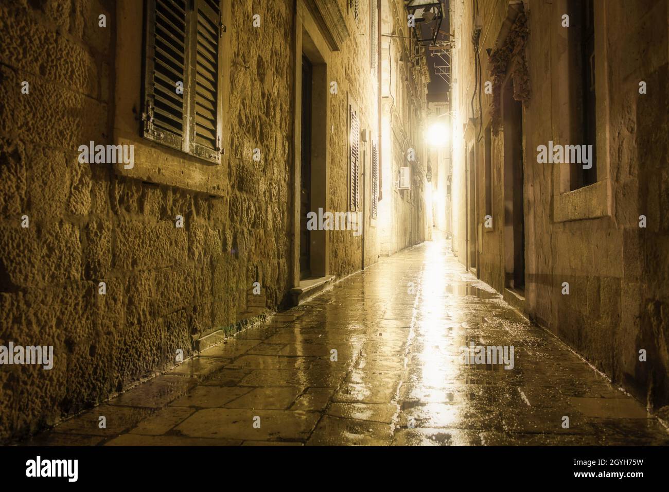 Old alleyway with lights through a building Stock Photo - Alamy