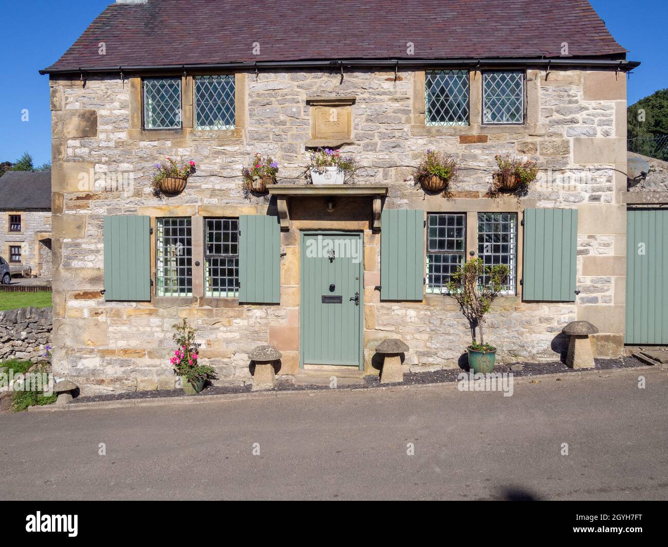 Frontage of a pretty stone built cottage in the Peak District village ...