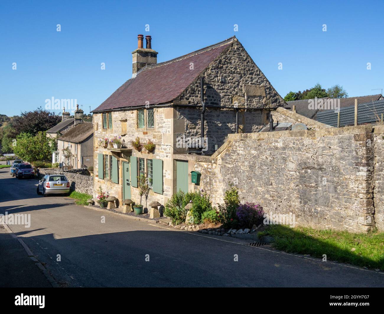 Street scene in summer in the pretty Peak District village of ...