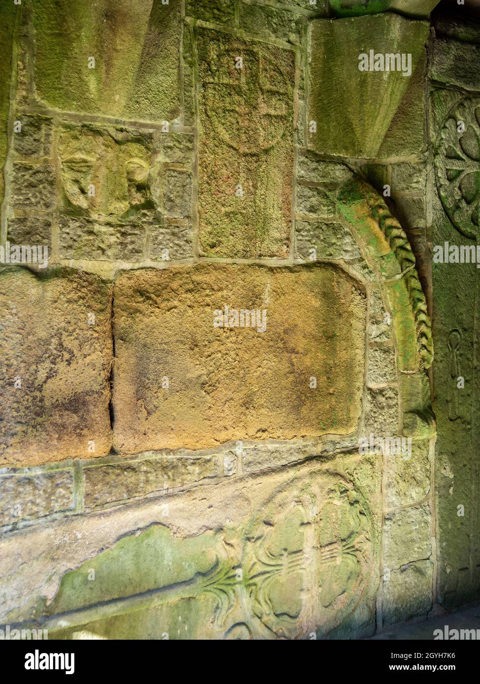 Old stone carved slabs in the south porch of the church of St John the ...