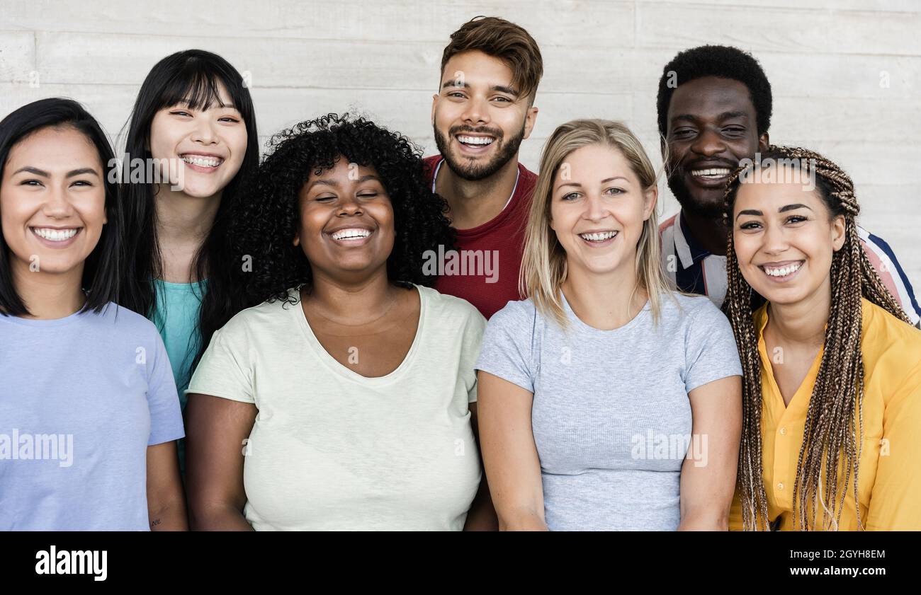 Happy multiracial friends having fun together looking at camera outdoor ...