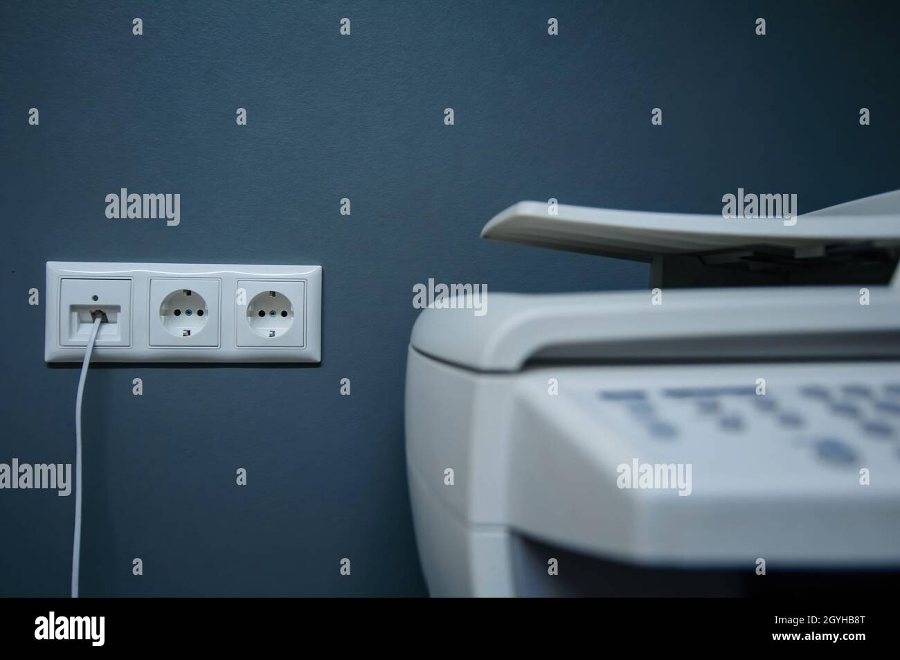 Front view of office power outlet with phone line connected and free ...