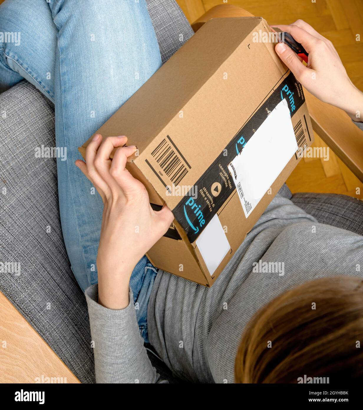 Overhead view of curious woman looking at new Amazon Prime Parcel Stock ...