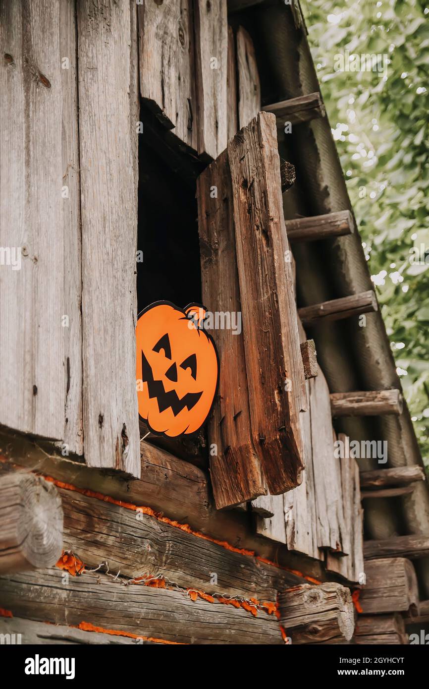 Halloween decor outdoors. Paper pumpkin on wooden building of the ...