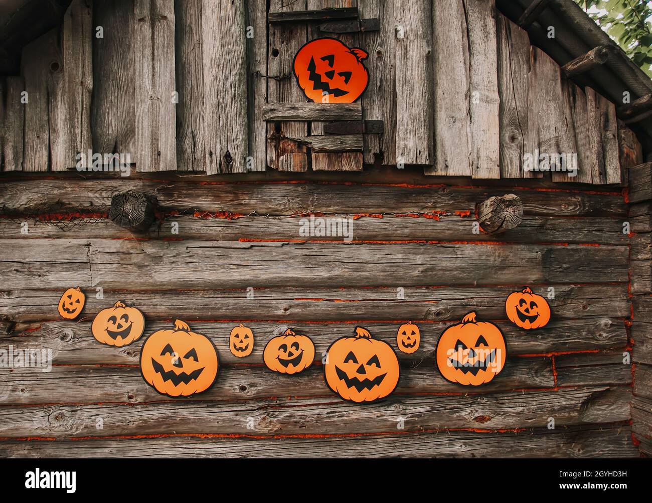 Halloween decor outdoors. Paper pumpkins on wooden building of the ...