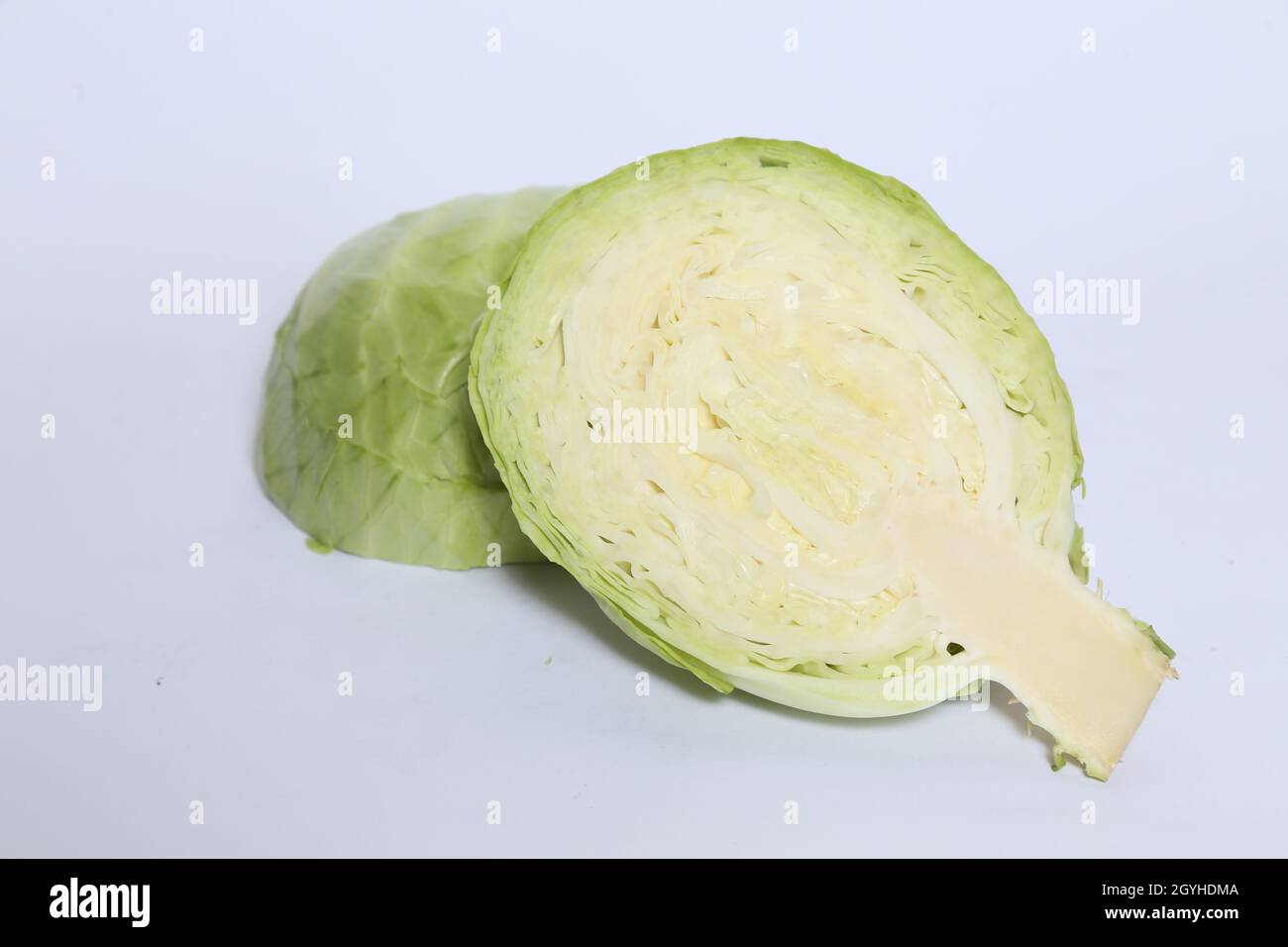 Closeup of a raw cabbage cut in half isolated on a white background ...