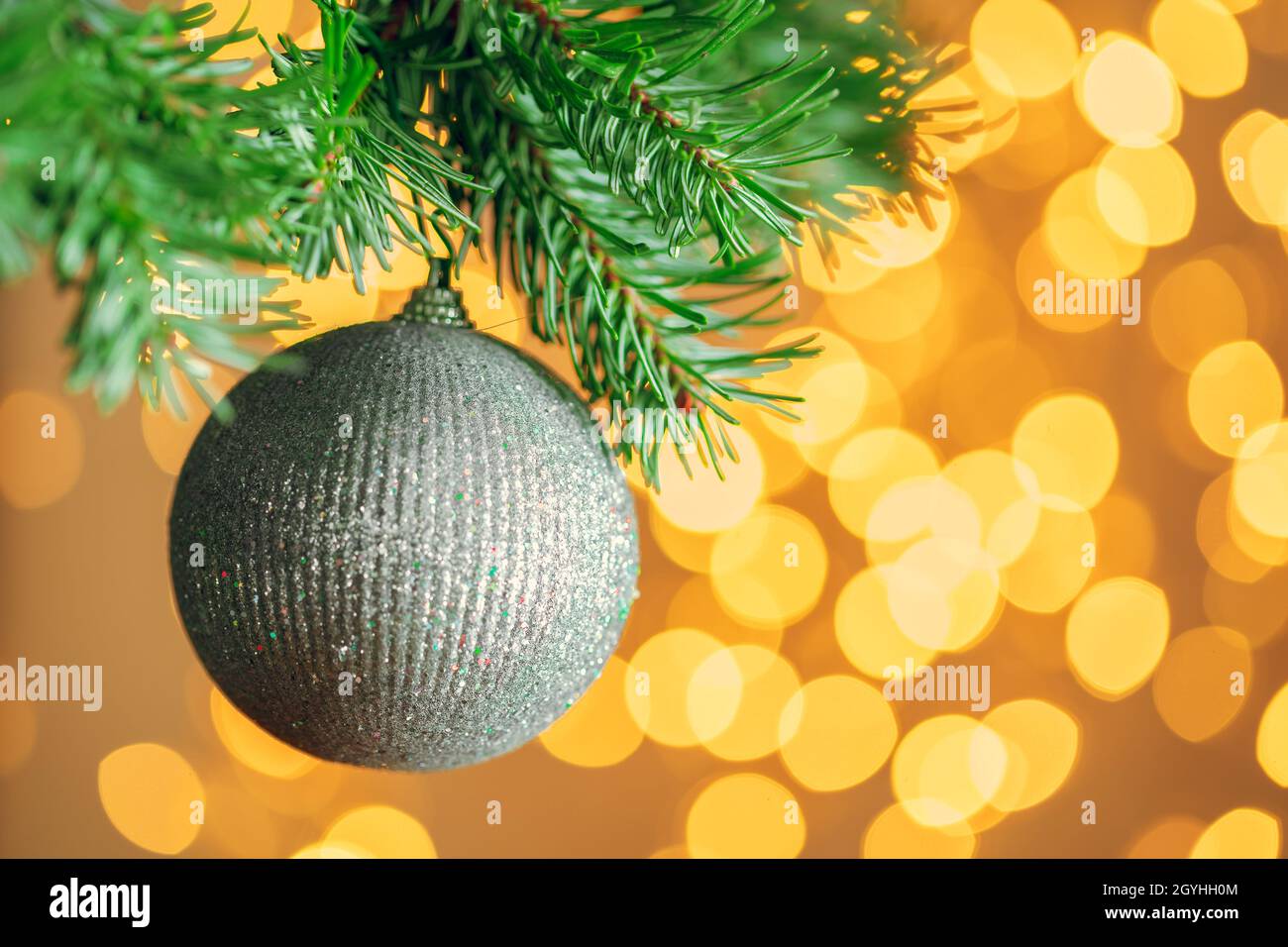 Christmas tree background with golden bauble on bokeh sparkling Stock Photo - Alamy