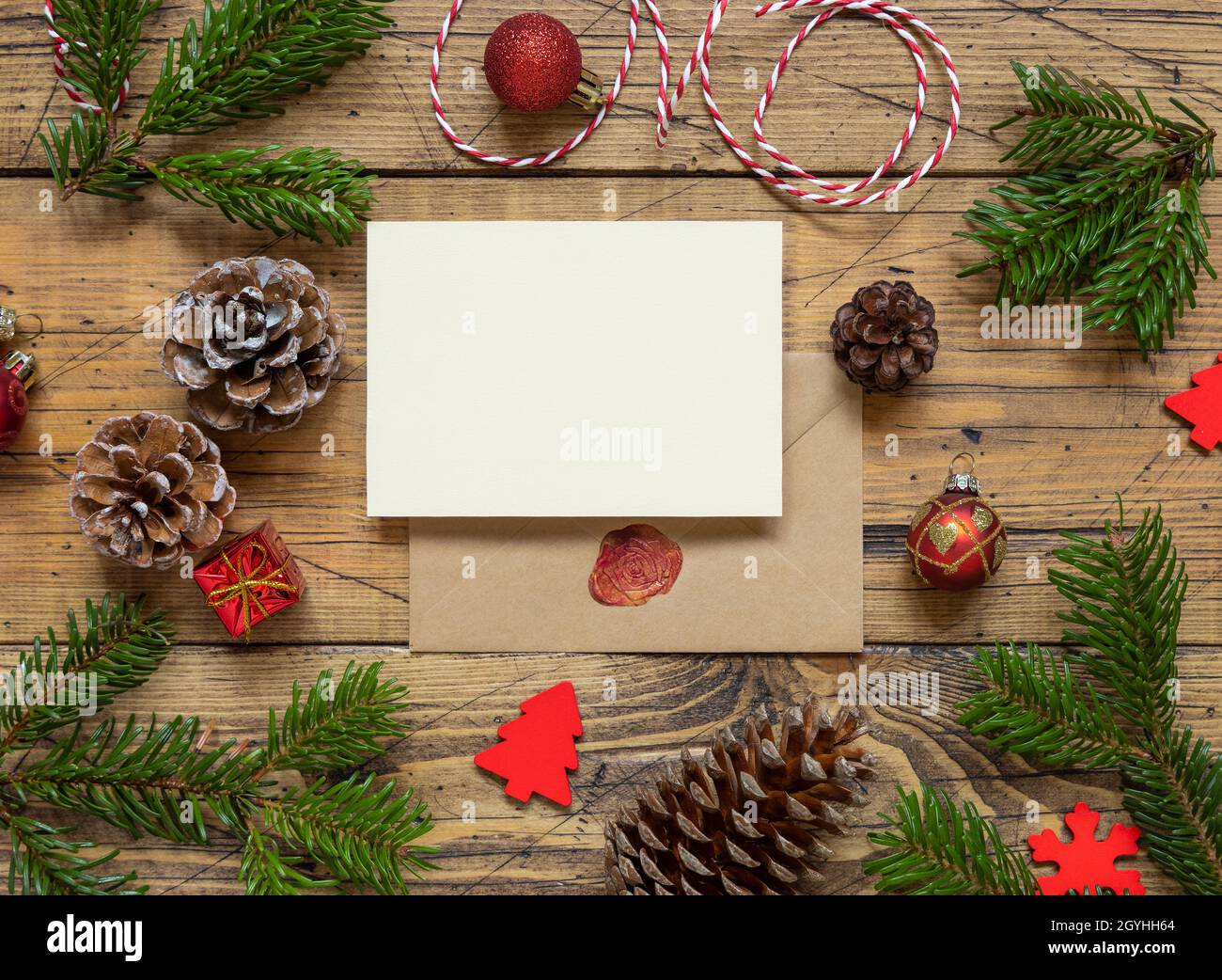 Winter Christmas Composition with a blank card and envelope over wooden ...