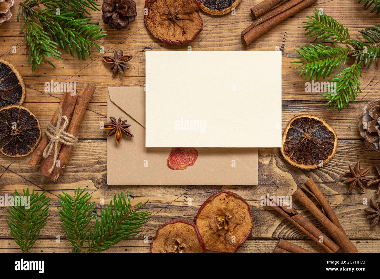 Winter Christmas Composition with a blank card and envelope on a wooden ...