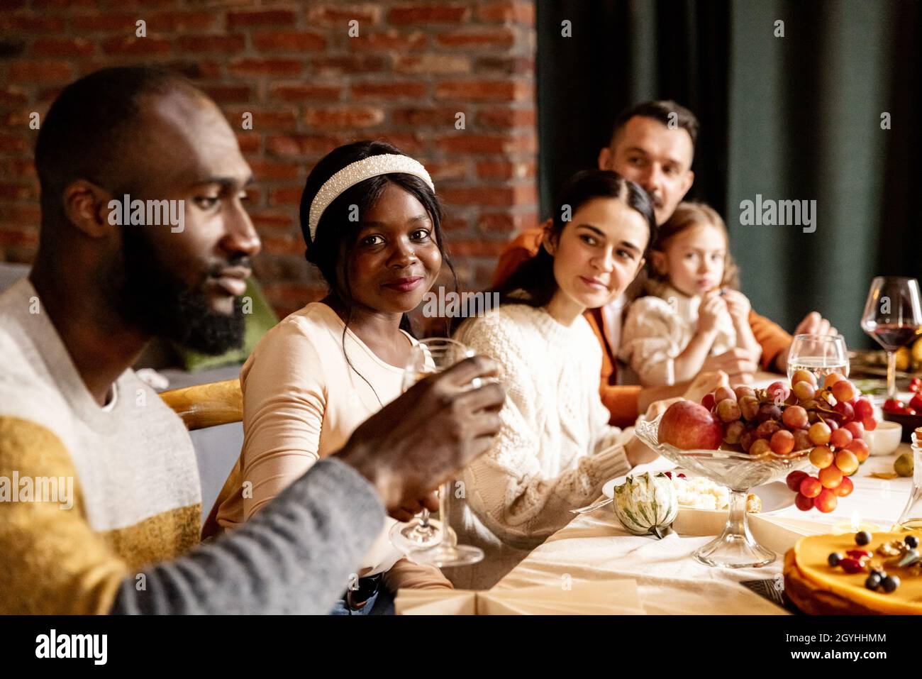 Happy Thanksgiving dinner party with family and friends with turkey and ...