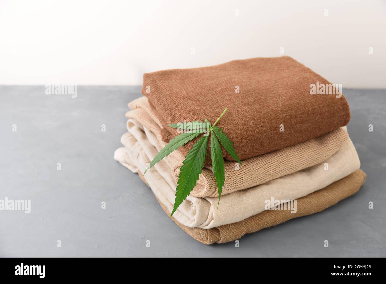 Stack of hemp clothes with cannabis leaf Stock Photo - Alamy