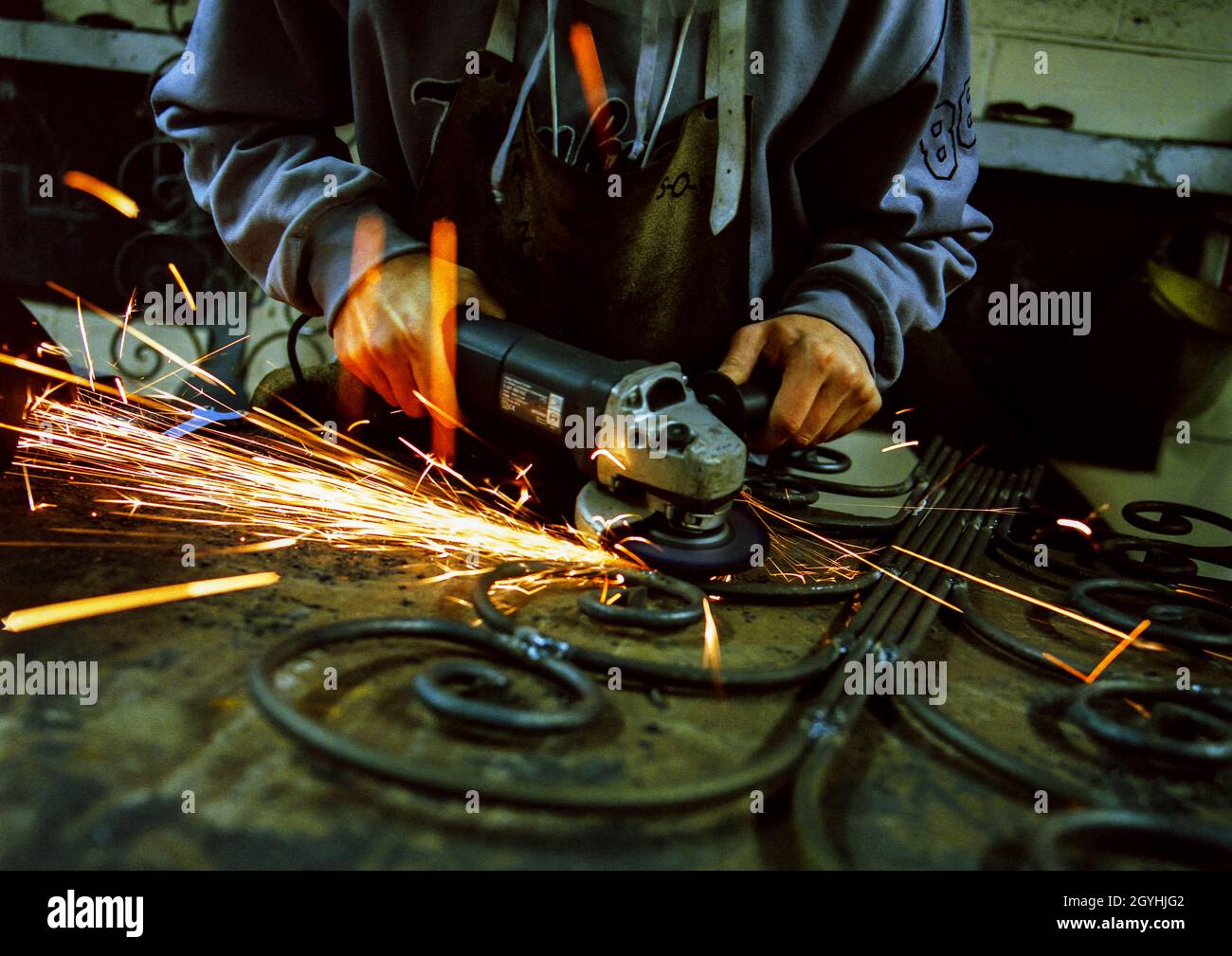 A Blacksmith grinding a metal art work London England UK Stock Photo ...