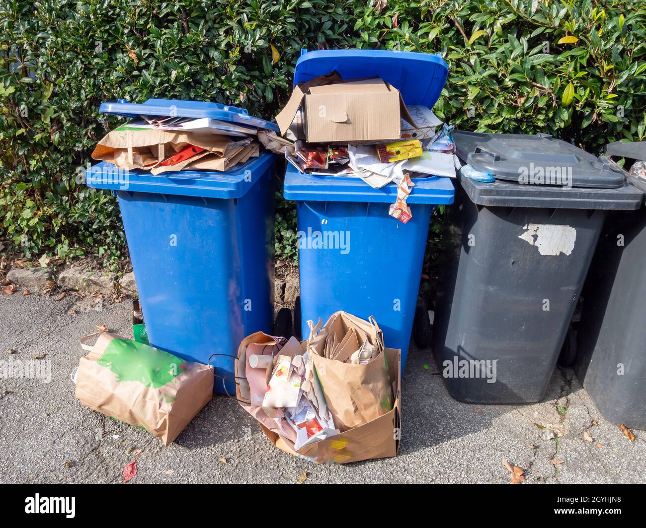 full garbage cans with paper garbage Stock Photo - Alamy
