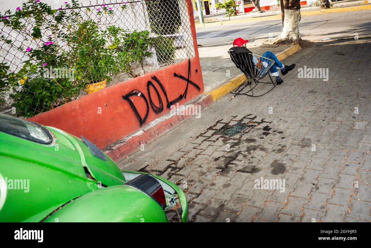 A Mexican man sitting in a chair in a street in Mazatlán Sinaloa Mexico ...