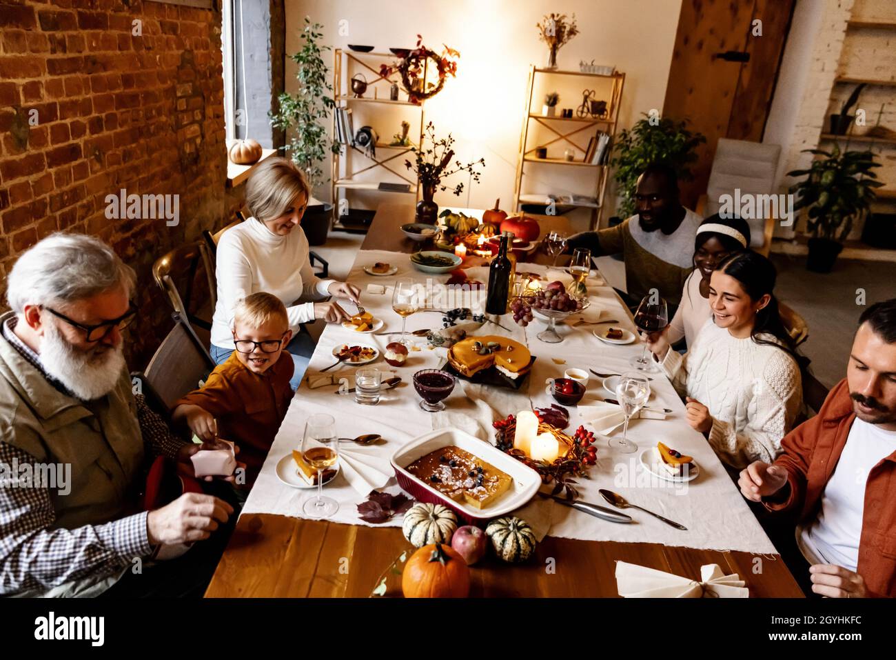 Happy Thanksgiving dinner party with family and friends with turkey and ...