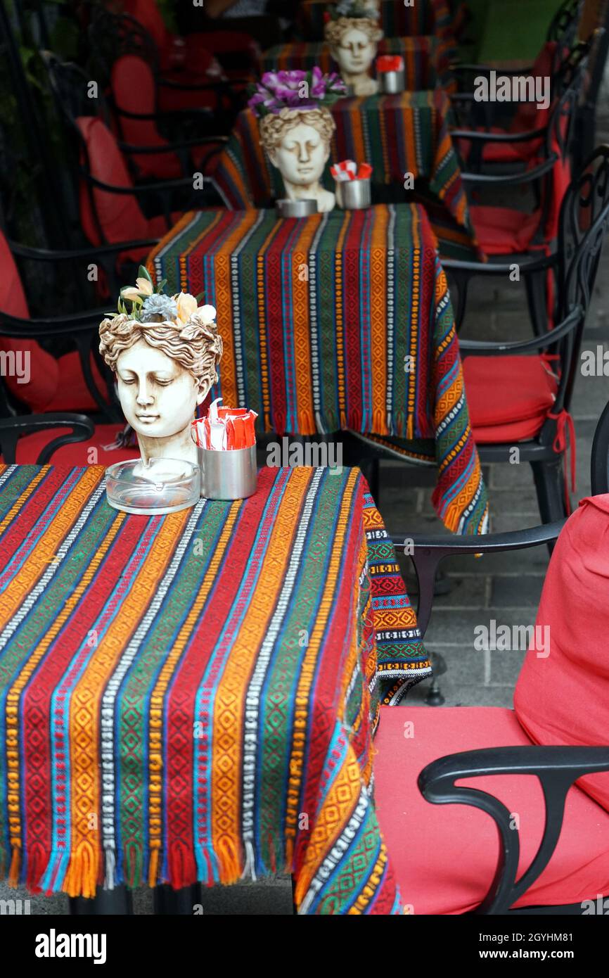 Vertical shot of decorative cafe tables with bust statues Stock Photo ...