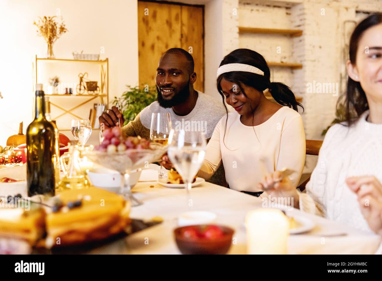 Happy Thanksgiving dinner party with family and friends with turkey and ...