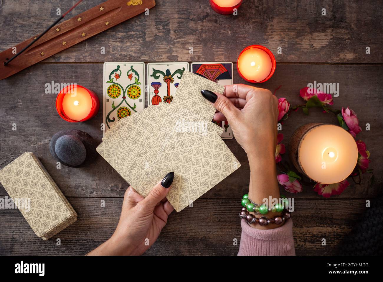 Fortune teller reading a future by tarot cards on rustic table Stock ...