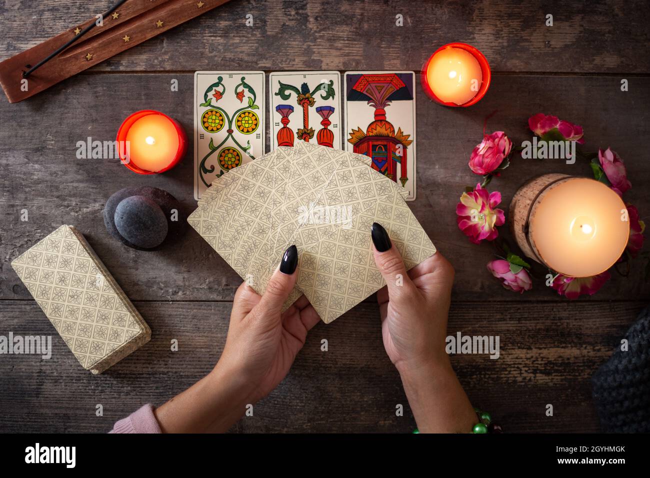 Fortune teller reading a future by tarot cards on rustic table Stock ...