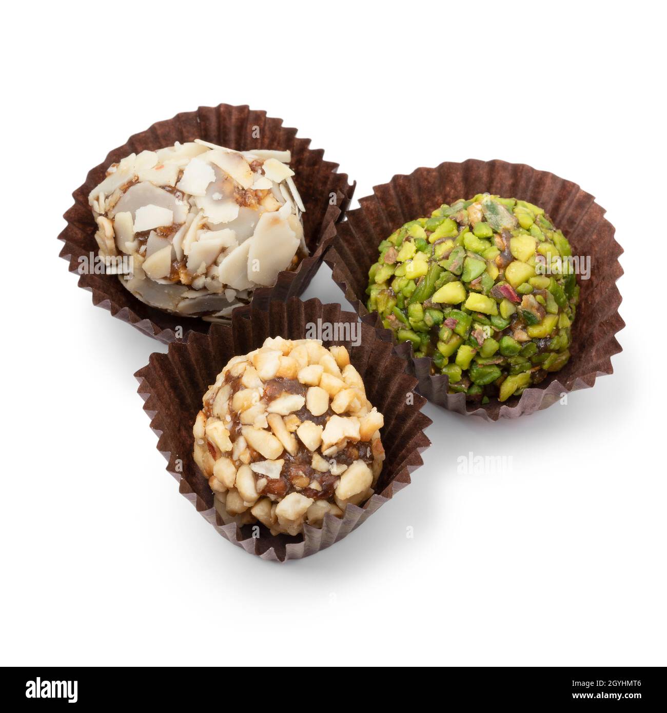 Sweet Turkisch date bonbons decorated with nuts isolated on white ...