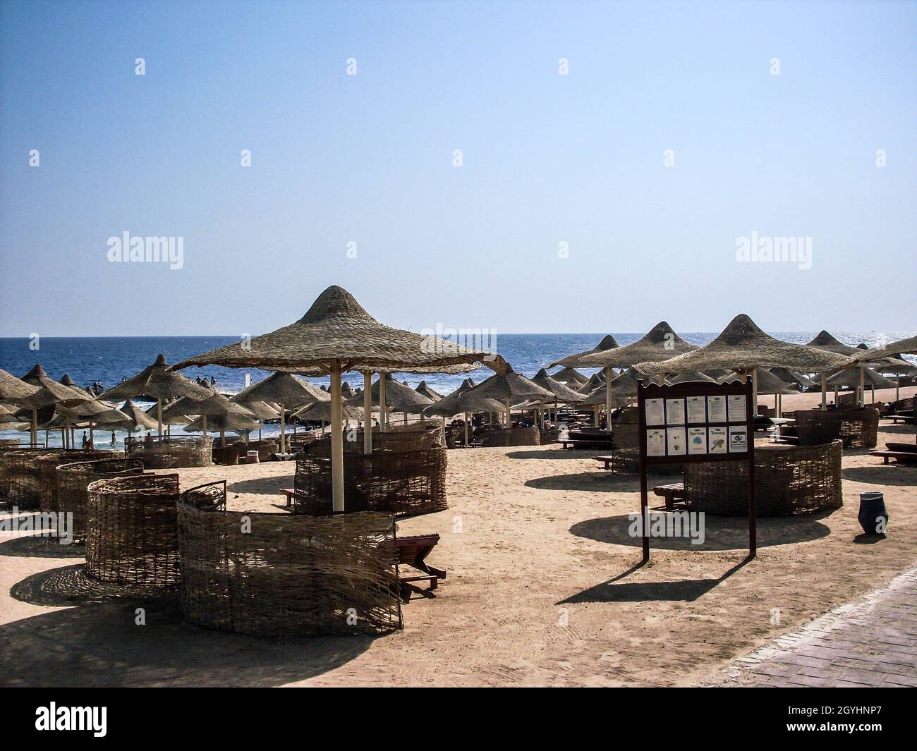 Beach at an egyptian resort at low tide with mountains in the ...