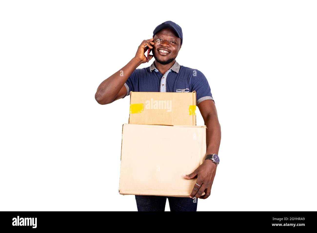 happy handsome young delivery man wearing blue uniform talking on ...