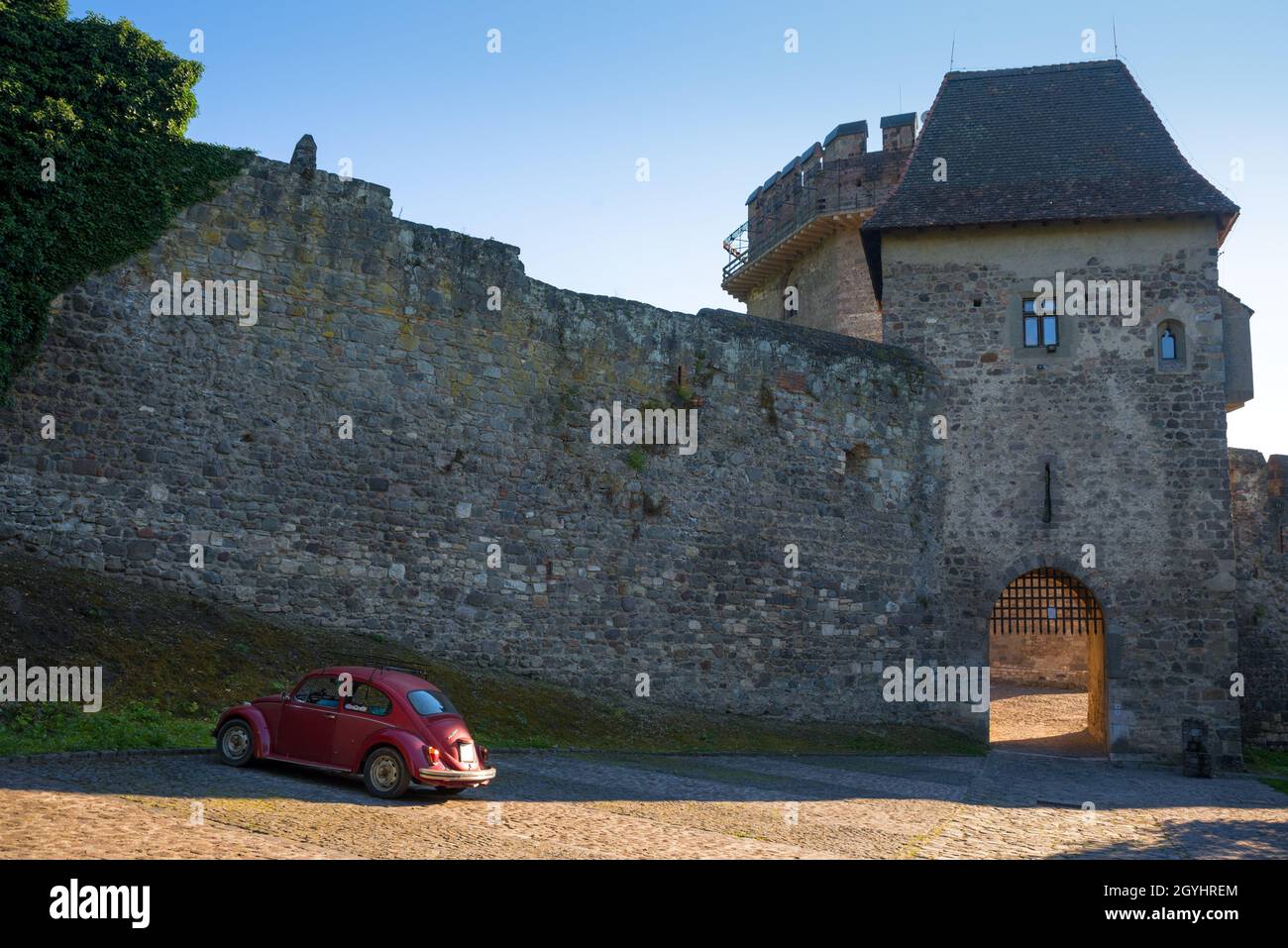 Old car standing by medieval fortress Stock Photo - Alamy