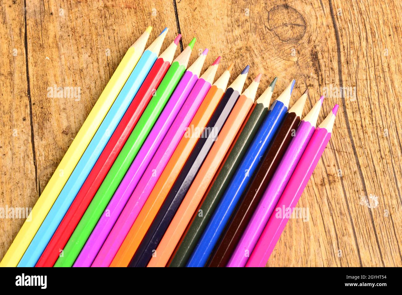 Colored pencils lined up on white background Stock Photo - Alamy