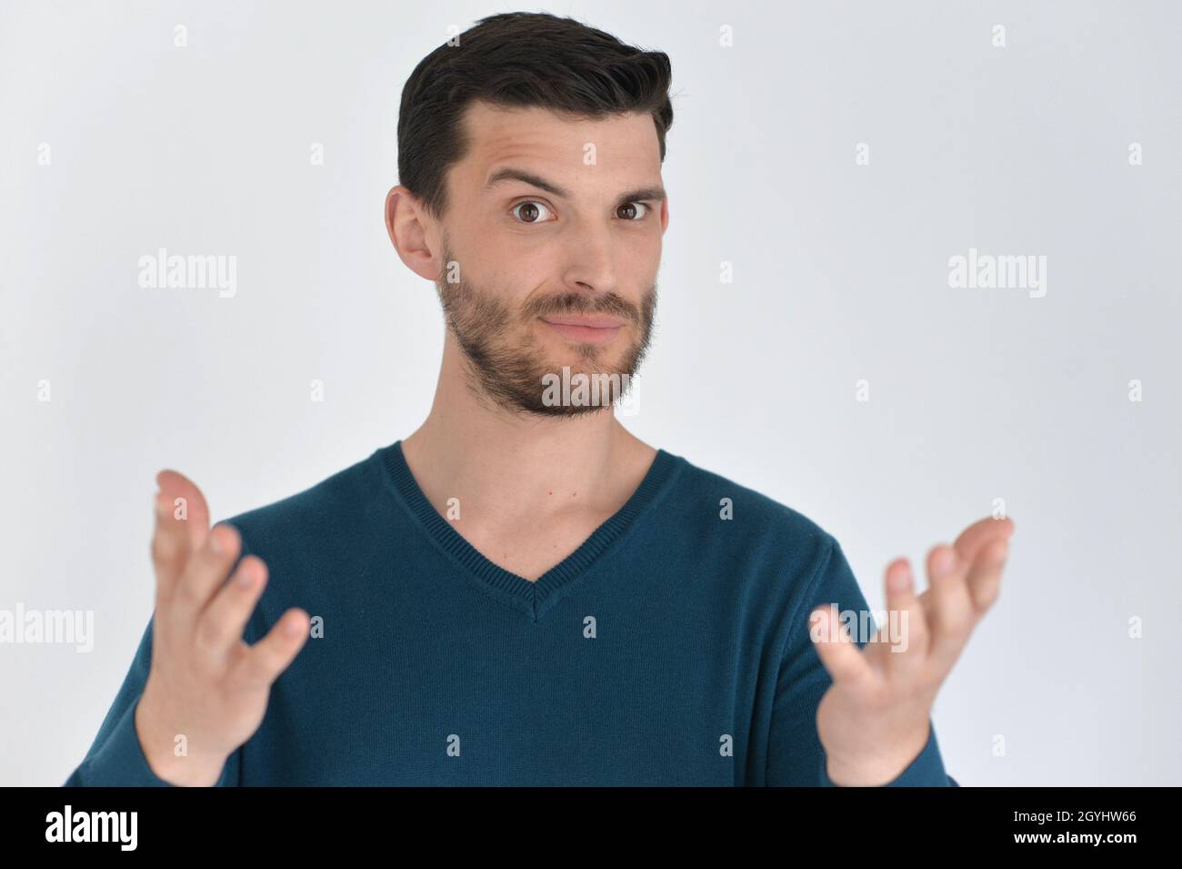 Handsome young man showing something in studio Stock Photo - Alamy