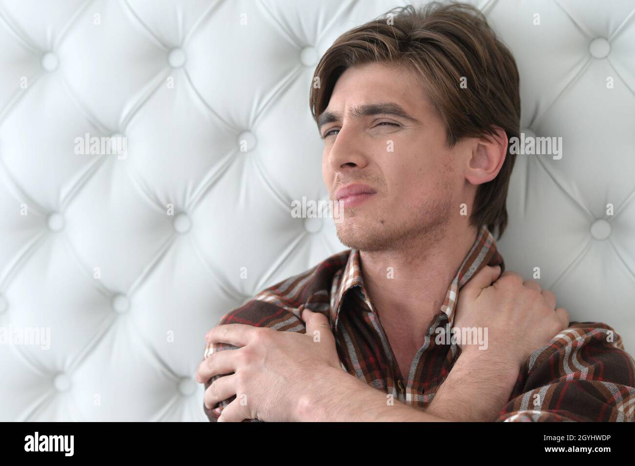 Handsome young man crying in studio Stock Photo - Alamy