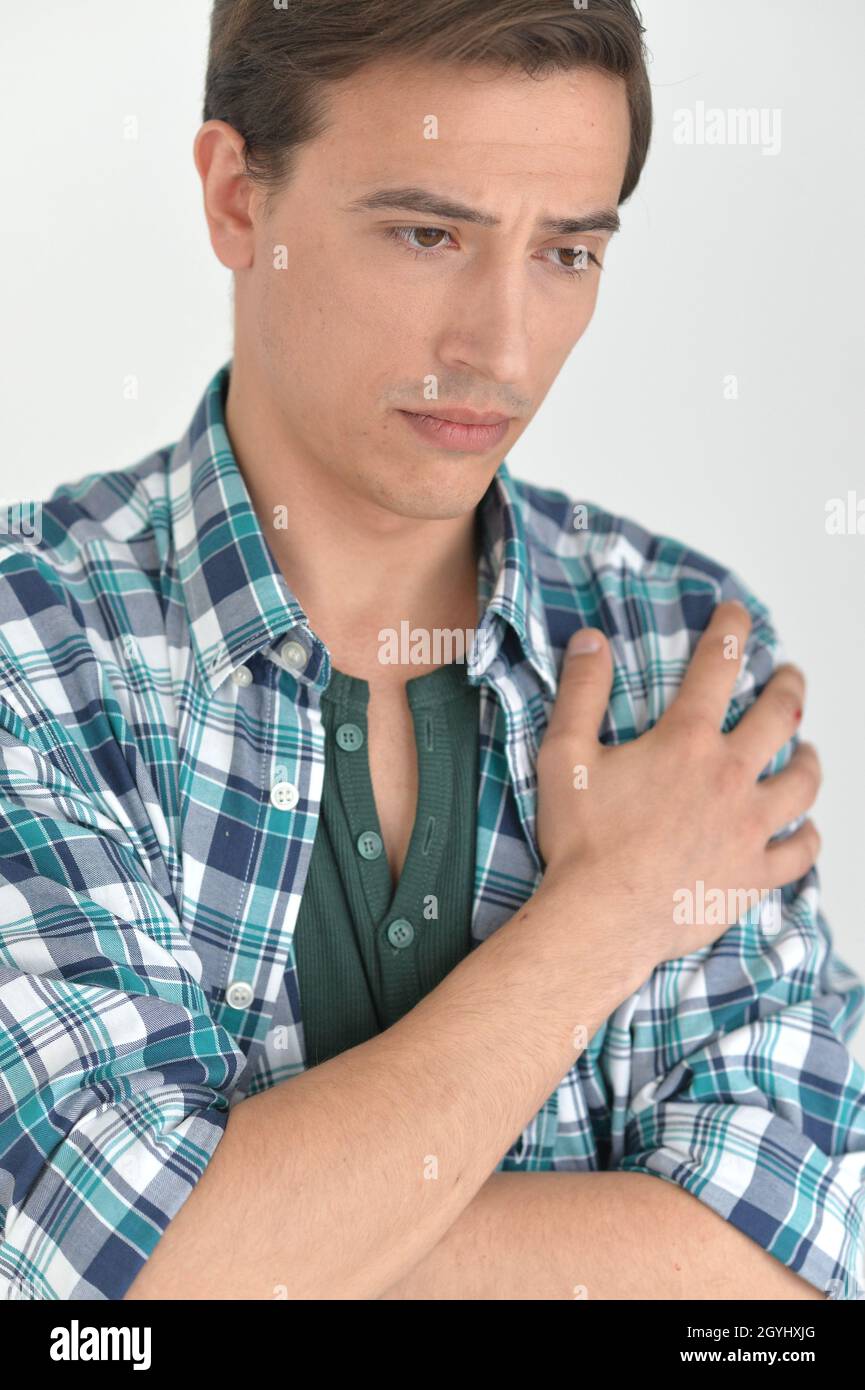 Portrait of handsome young man thinking in studio Stock Photo - Alamy