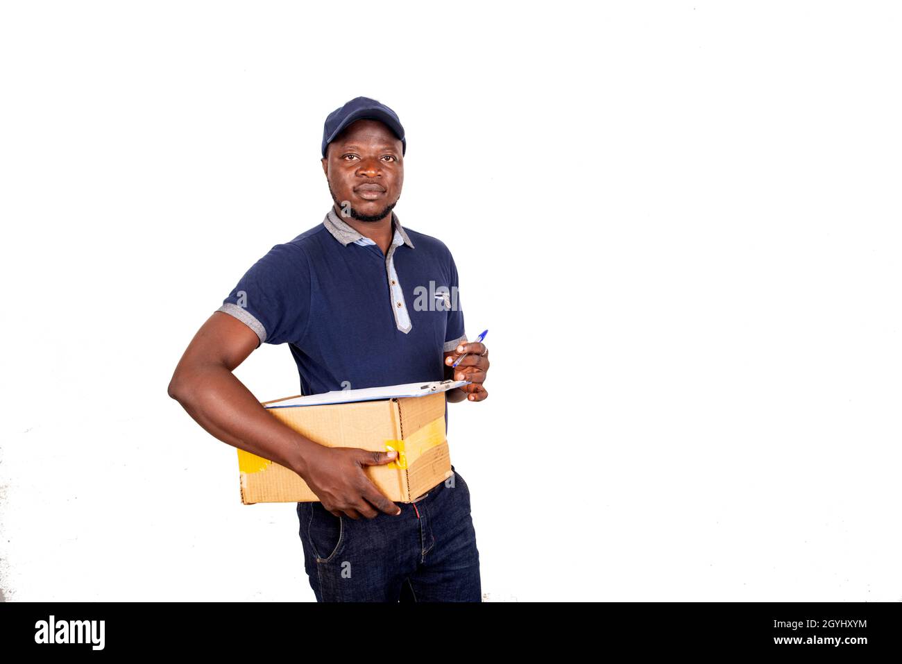happy handsome young delivery man in blue uniform holding a paper press ...