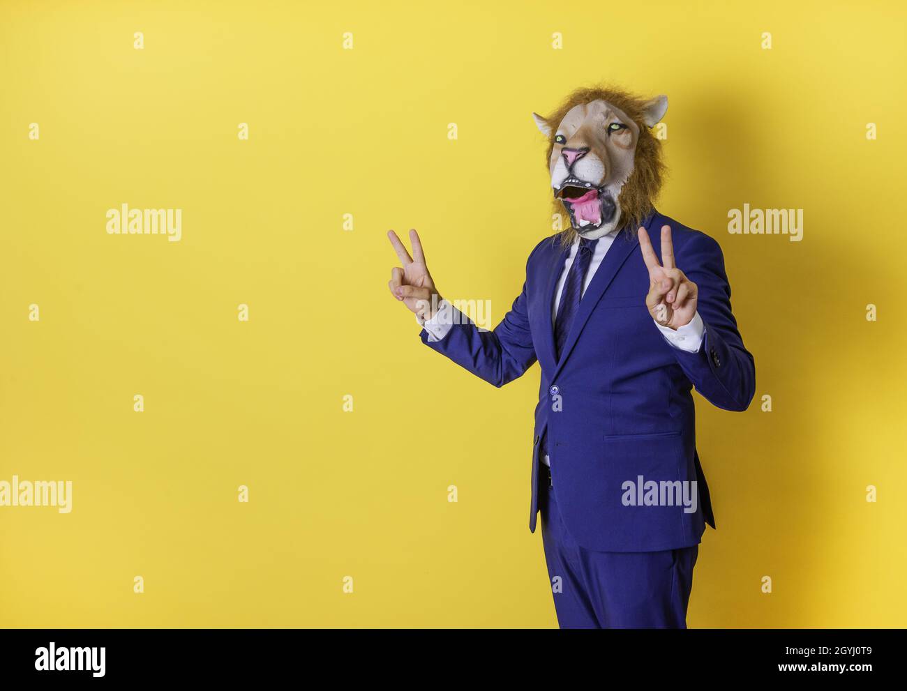 Businessman in lion mask making a victory gesture with both hands Stock ...