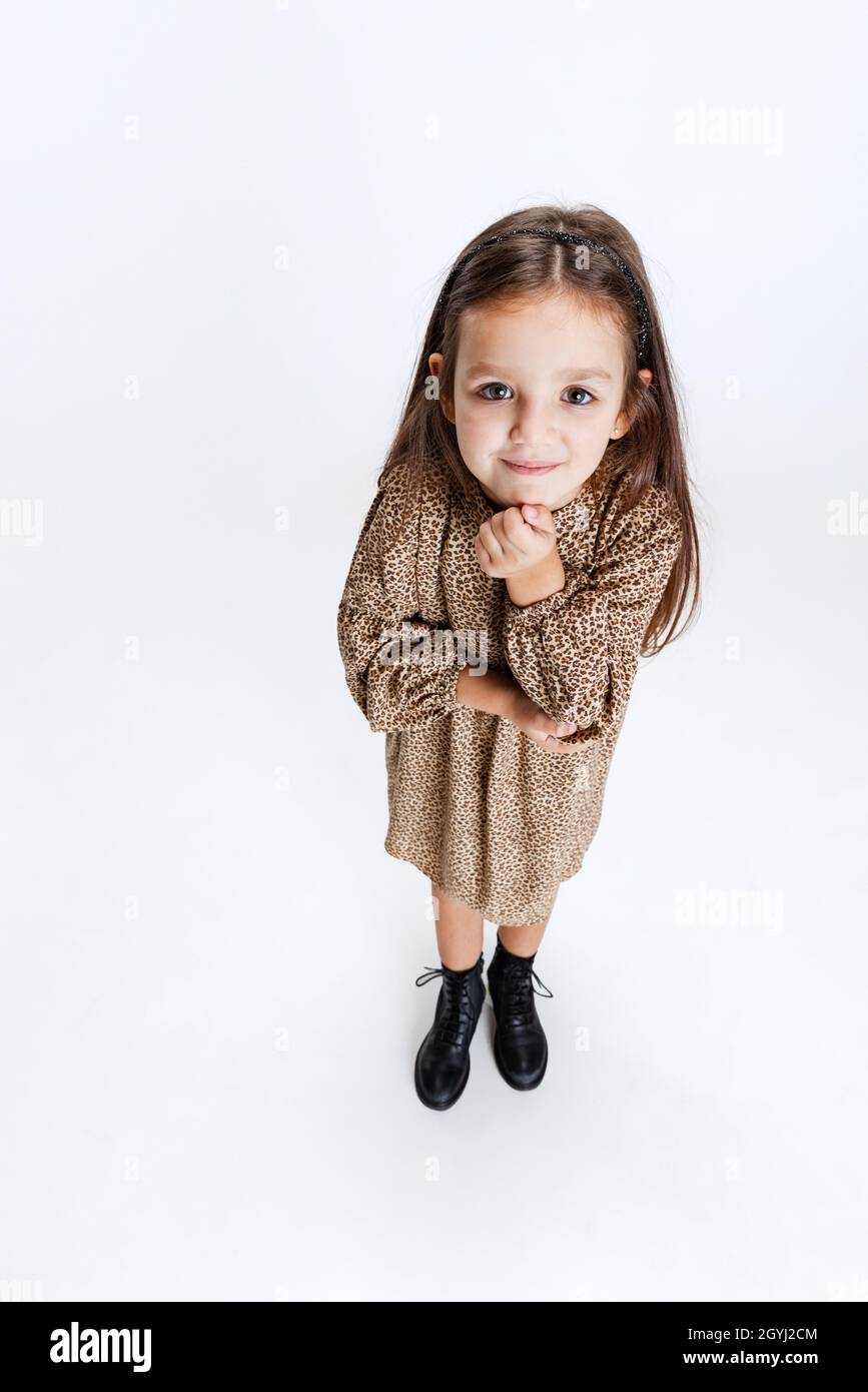 High angle view of little cute smiling preschool beautiful girl looking ...