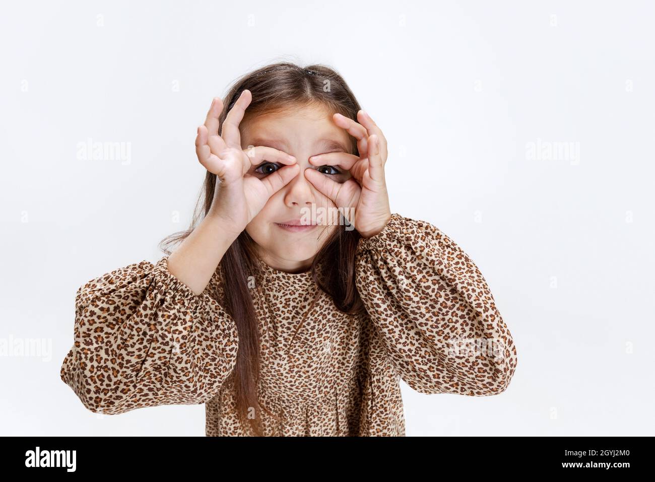 High angle view of little cute smiling preschool beautiful girl looking ...