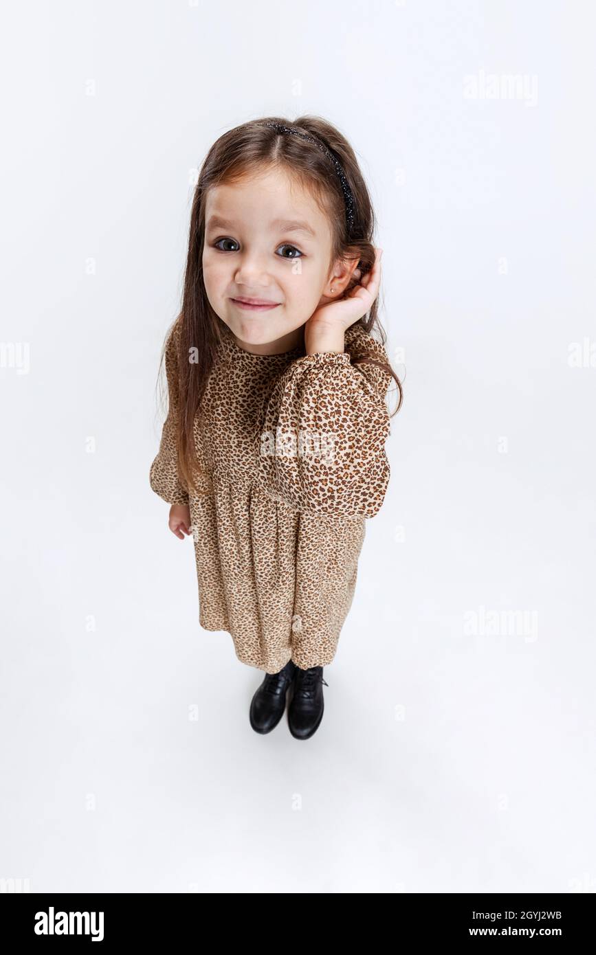 High angle view of little cute smiling preschool beautiful girl looking ...