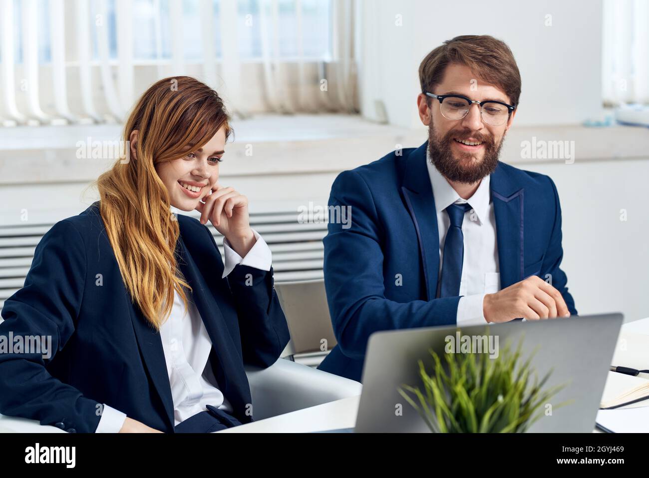 man and woman managers work together in front of laptop professionals ...