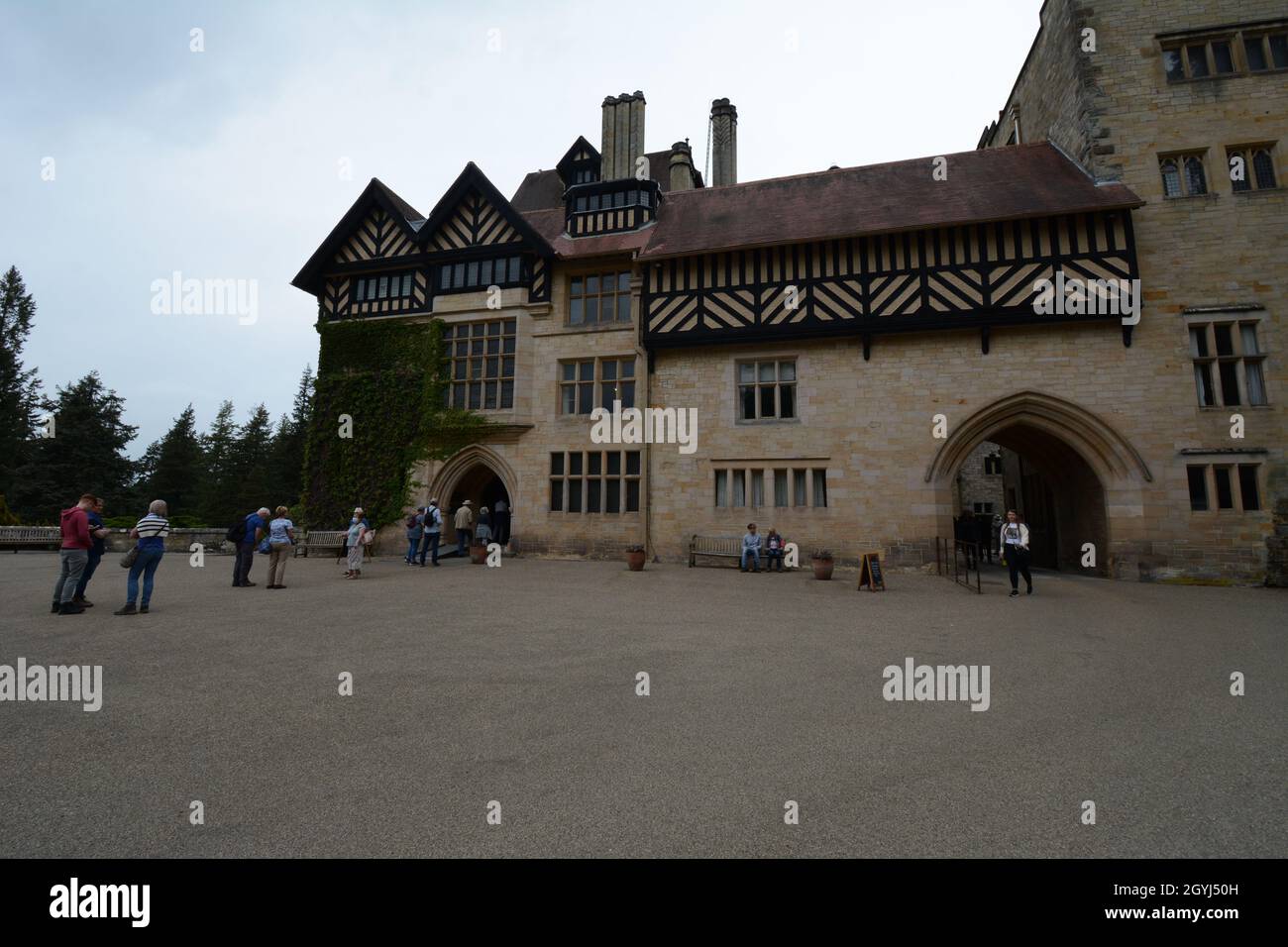 Cragside Northumberland National Trust house arch people entrance old ...