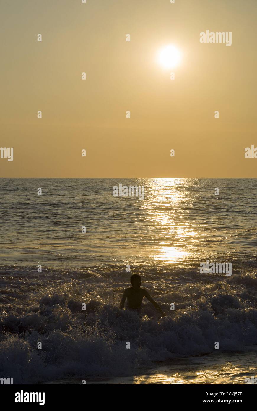 Silhouette at sunset of person facing the sea in Guatemala, south coast ...