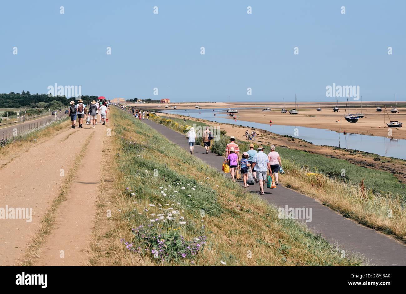 Summer tourists walking the raised beach footpath in Wells Next To The ...