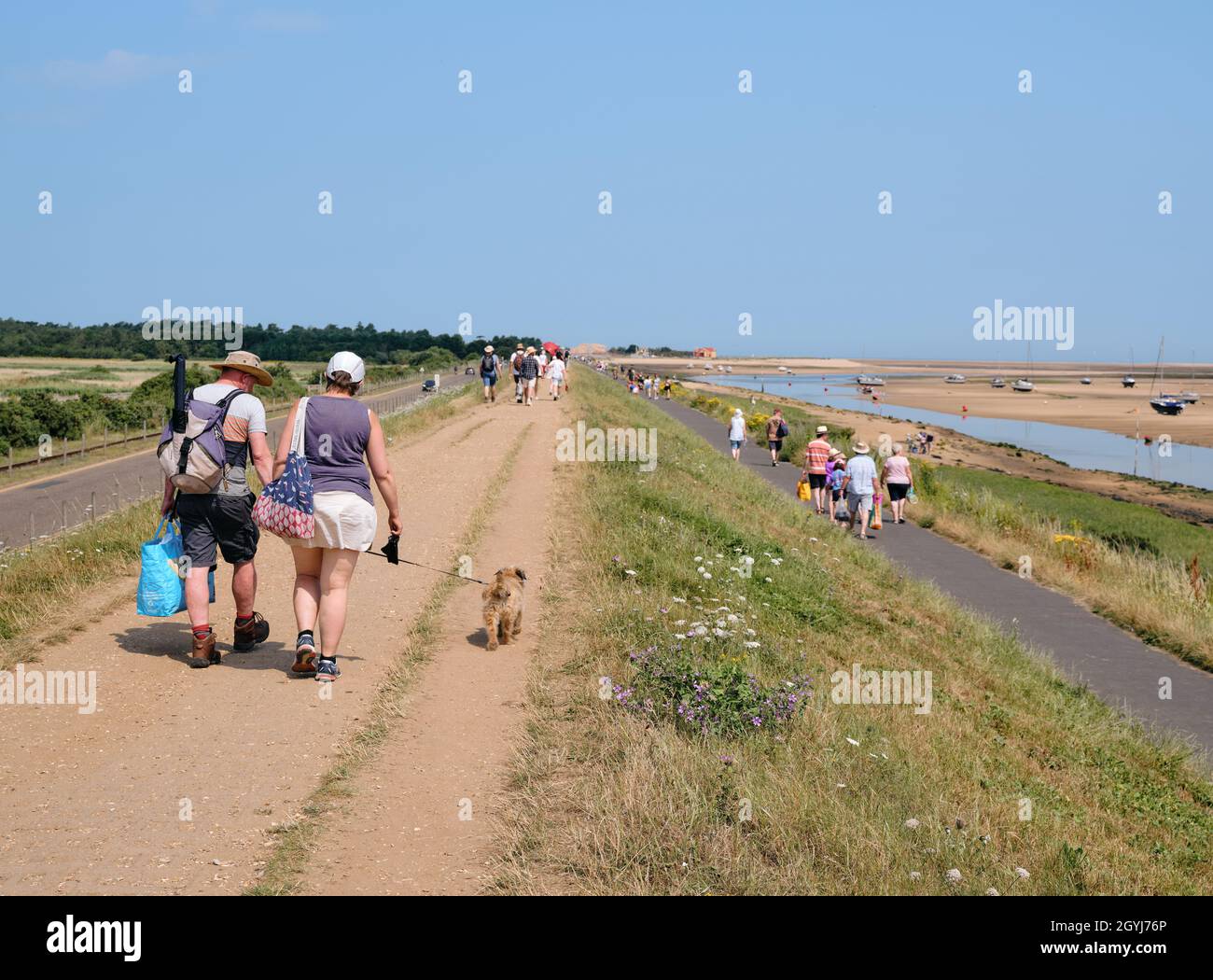 Summer tourists walking the raised beach footpath in Wells Next To The ...