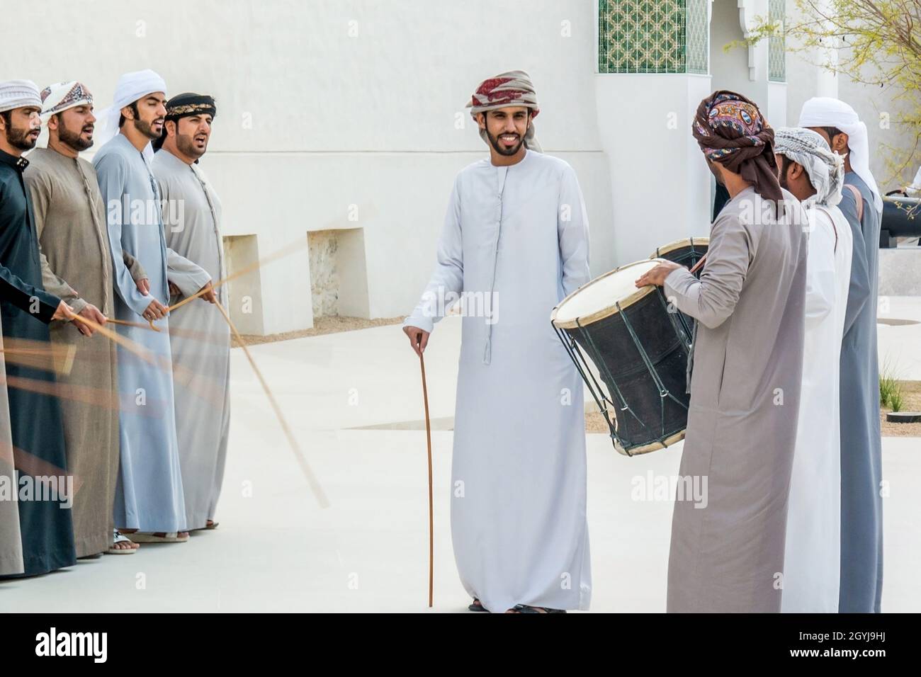 Emirati Men performing the Yowla, a traditional dance in the heritage ...