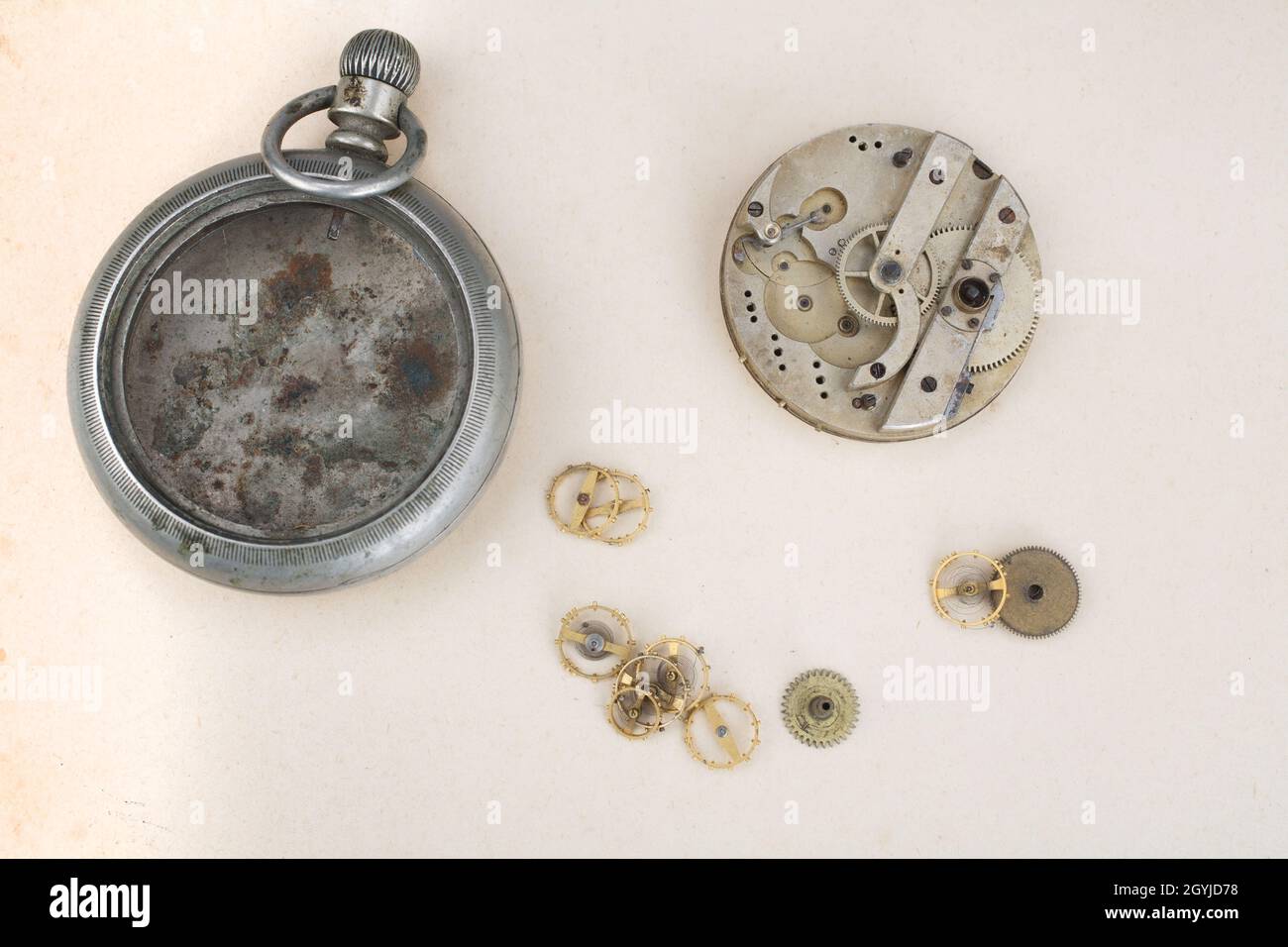 broken vintage pocket watch on paper background Stock Photo - Alamy