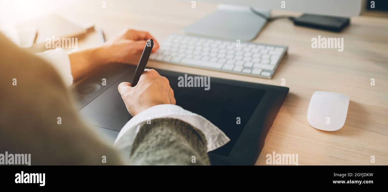 Female's hands using a graphic tablet with stylus pen and modern ...